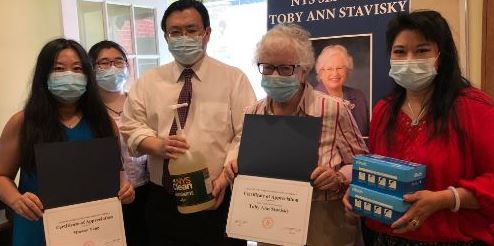 Senator Toby Ann Stavisky (D-16th District) provides hand sanitizer and ...